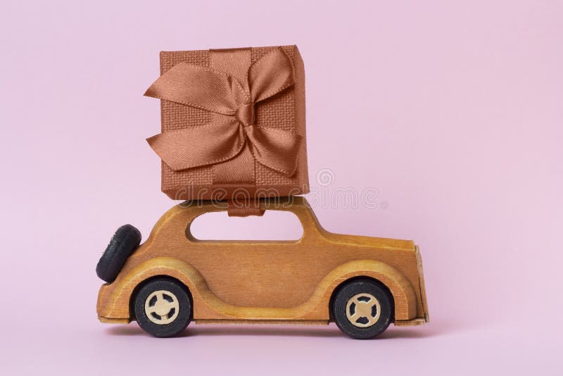 Wooden Car with a Gift on a Pink Background Stock Photo - Image of ...