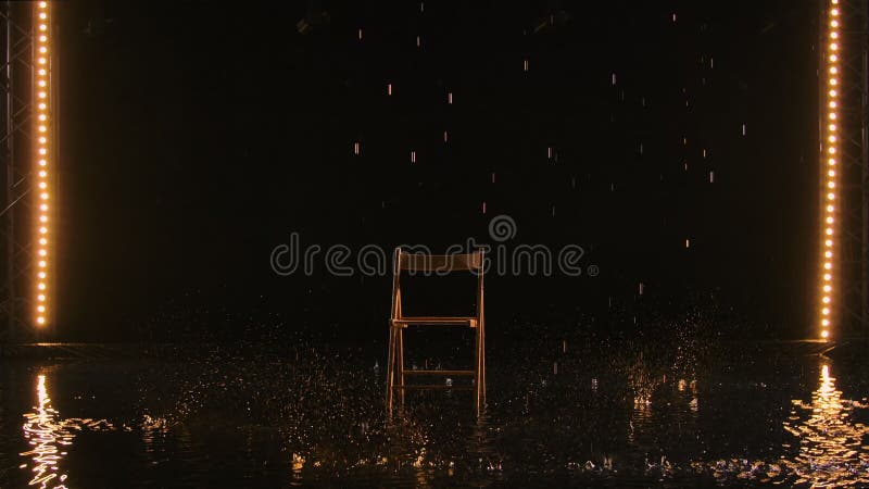 A Wooden Chair Stands in the Rain on the Water Surface in an Empty Dark ...