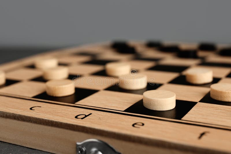 Wooden Checkerboard with Game Pieces on Light Grey Background, Closeup ...