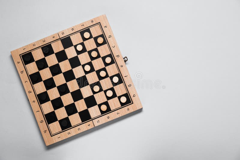 Wooden Checkerboard with Game Pieces on Light Grey Background, Top View ...