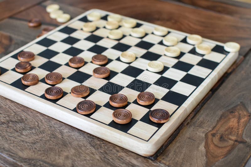 Wooden checkers on a board stock photo. Image of isolated - 370878942