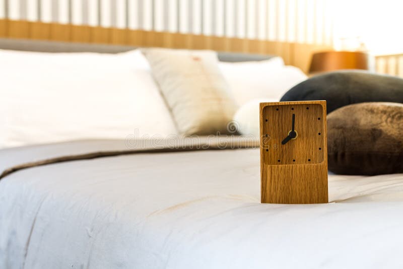 Wooden clock on bed stock image. Image of time, square - 57614281