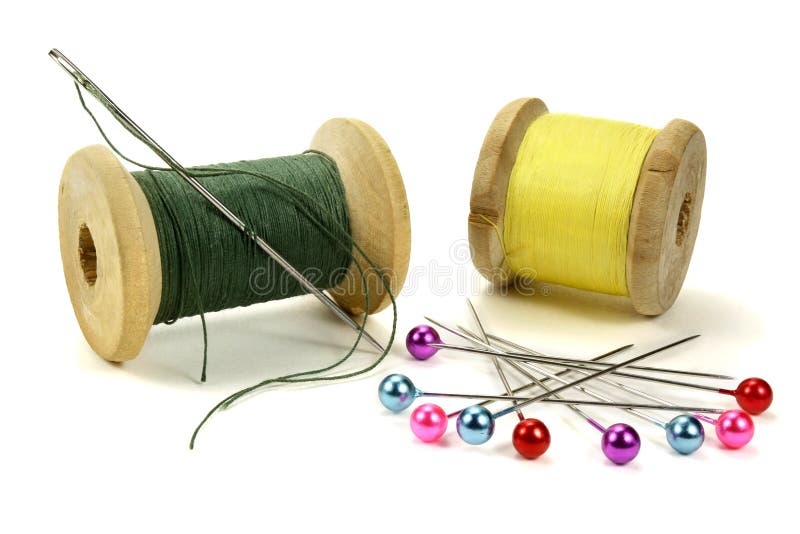 Wooden Coils with Threads, Pins and Needle for Sewing on a White ...