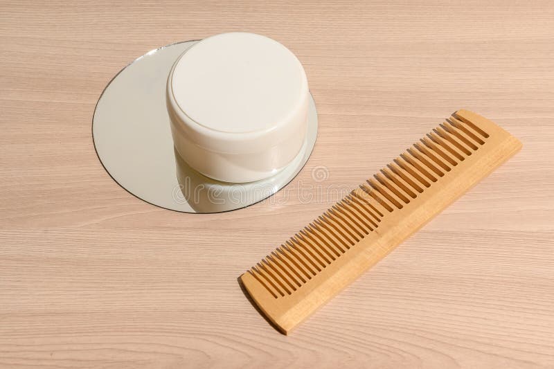 Wooden Comb, Cosmetic Cream and Mirror. on a Wooden Table Stock Image ...