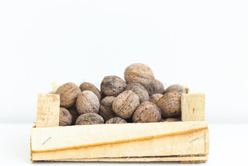 Wooden Container with Walnuts on a White Table Stock Image - Image of ...