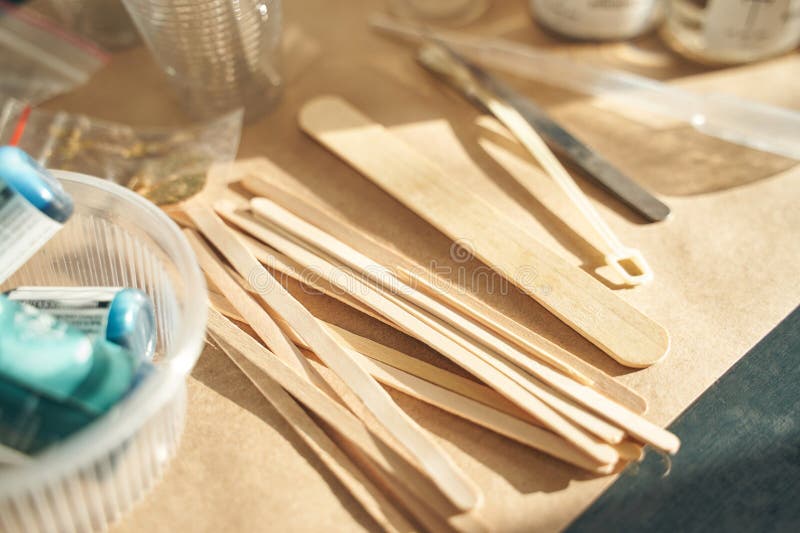 Wooden Craft Sticks and Tools Arranged on a Workshop Table with Blue ...