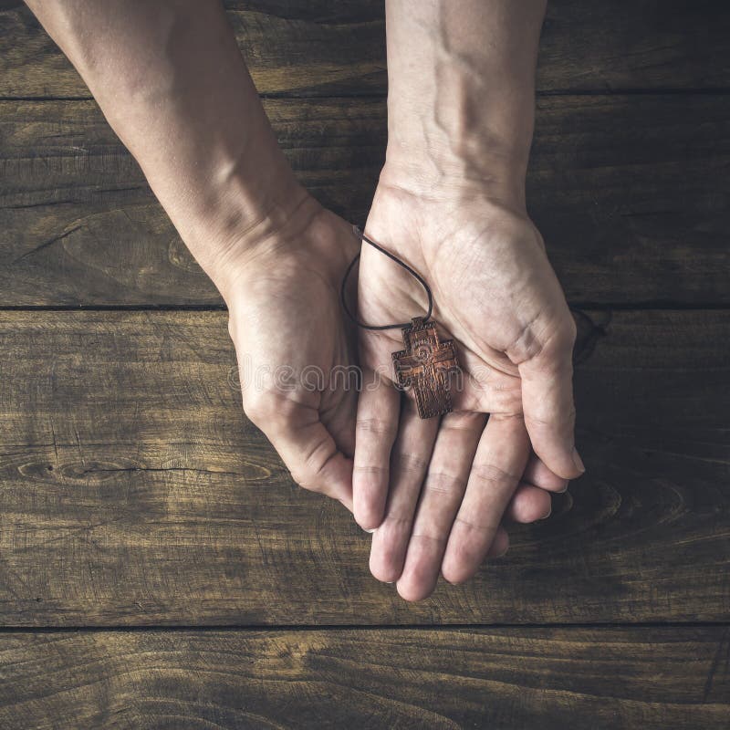 Wooden cross on hands stock photo. Image of handful, cross - 94334066