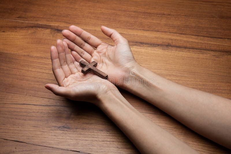 Wooden cross in the hands stock photo. Image of hand - 60322392