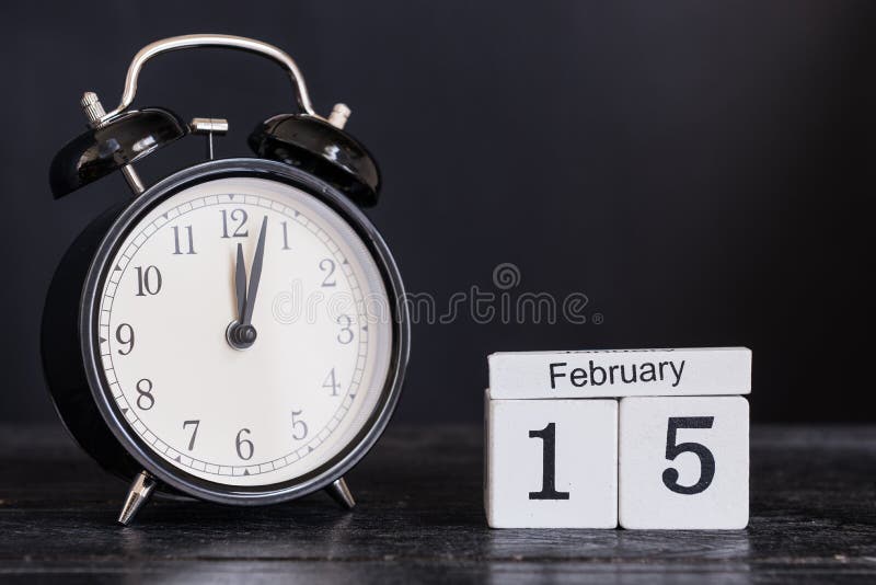 Wooden Cube Shape Calendar for February 15 with Black Clock. Stock ...