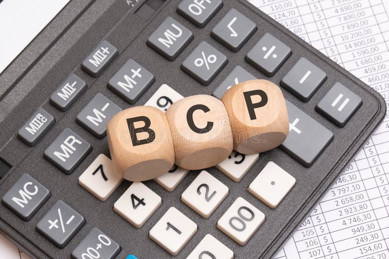 Wooden Cubes with BCP on Calculator and Financial Spreadsheets Stock ...