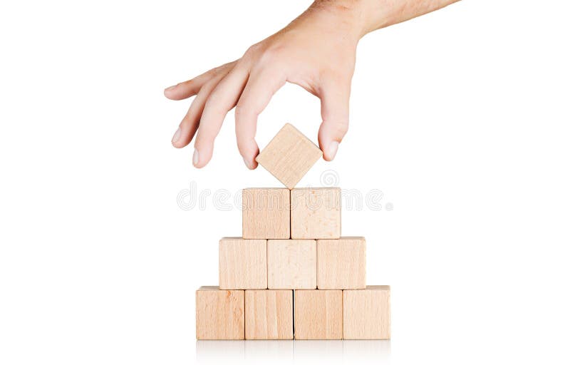Wooden Cubes in the Form of a Pyramid with a Hand on an Isolate White ...