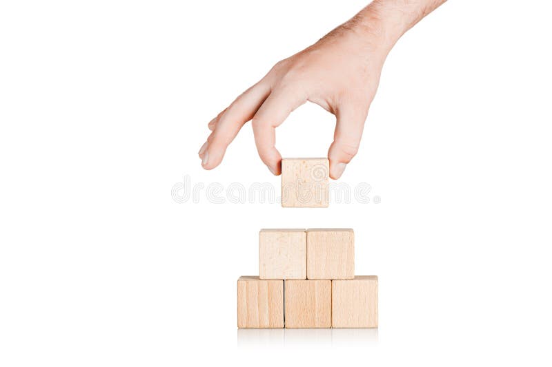 Wooden Cubes in the Form of a Pyramid with a Hand on an Isolate White ...
