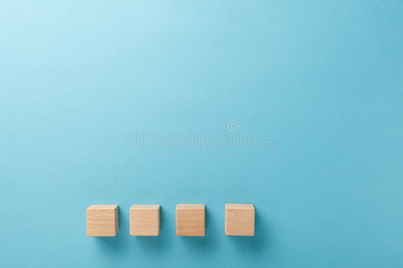 Wooden Cubes Four Pieces in a Row on a Blue Background Stock Image ...