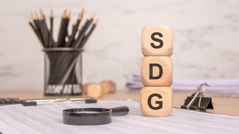 Wooden Cubes with SDG Letters on Office Table Stock Photo - Image of ...