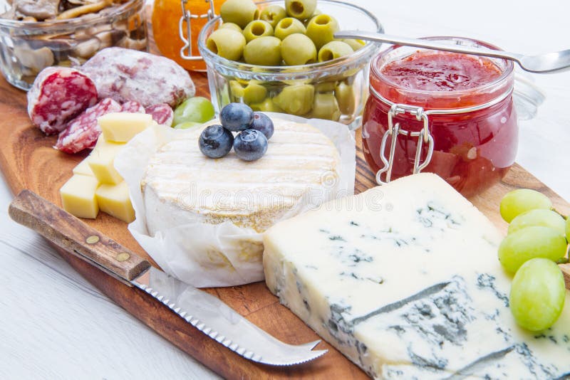 Wooden Cutting Board with Cheese, Cold Cuts and Jams Stock Photo ...