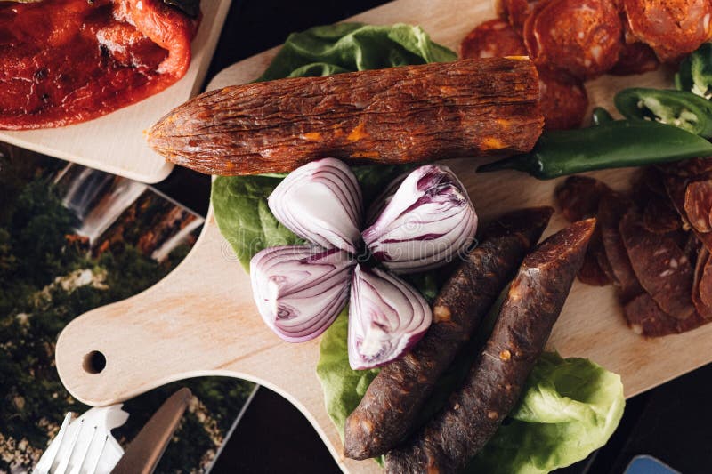 Wooden Cutting Board with a Variety of Cured Meats. Stock Photo - Image ...