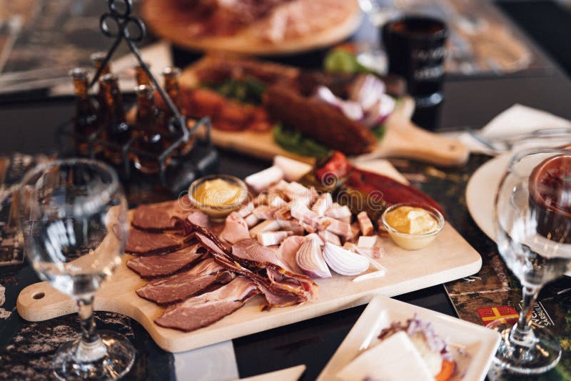 Wooden Cutting Board with a Variety of Cured Meats. Stock Photo - Image ...