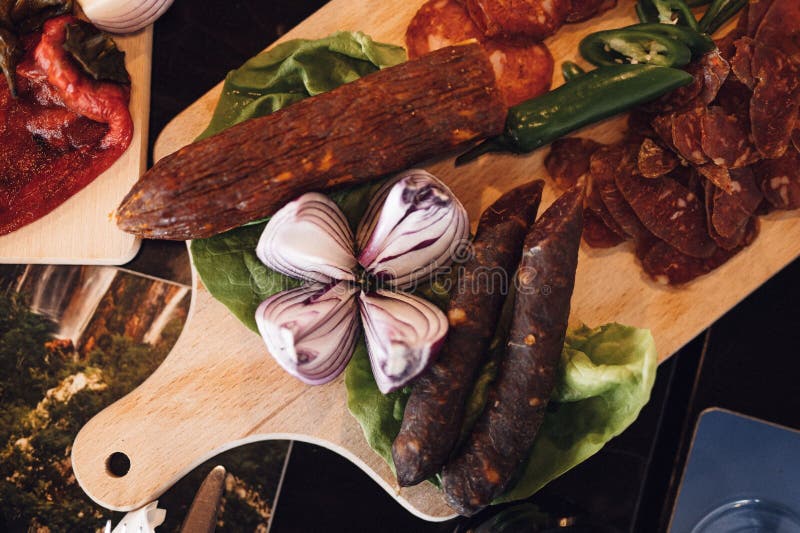 Wooden Cutting Board with a Variety of Cured Meats. Stock Photo - Image ...