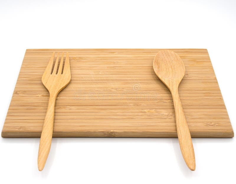 A Wooden Cutting Board with Wooded Spoon and Fork on the White ...
