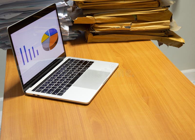 Wooden Desk with Laptop and Full of Stacked Documents Stock Photo ...