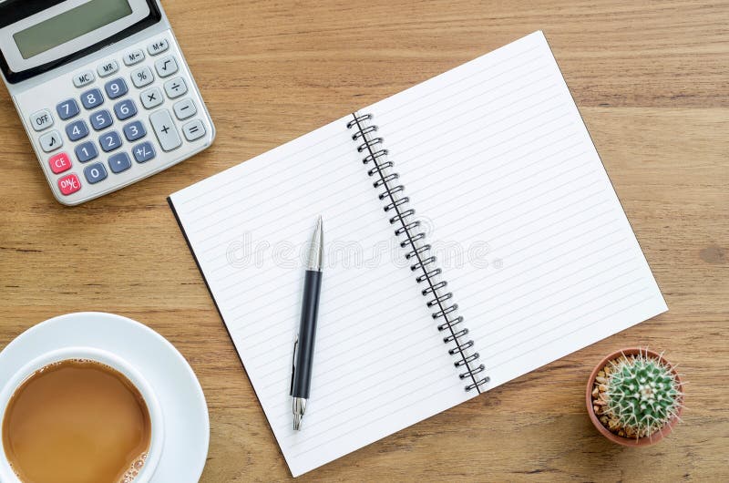 Wooden Desk Table with Notebook, Pen, Calculator and Cup of Coffee. Top ...