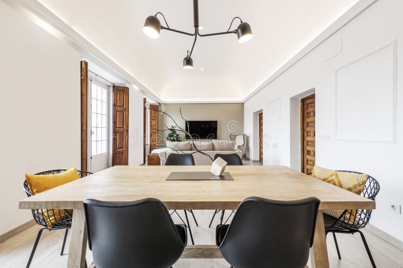 Wooden Dining Table in a Living Room with Sofas and Wood Paneled Access ...