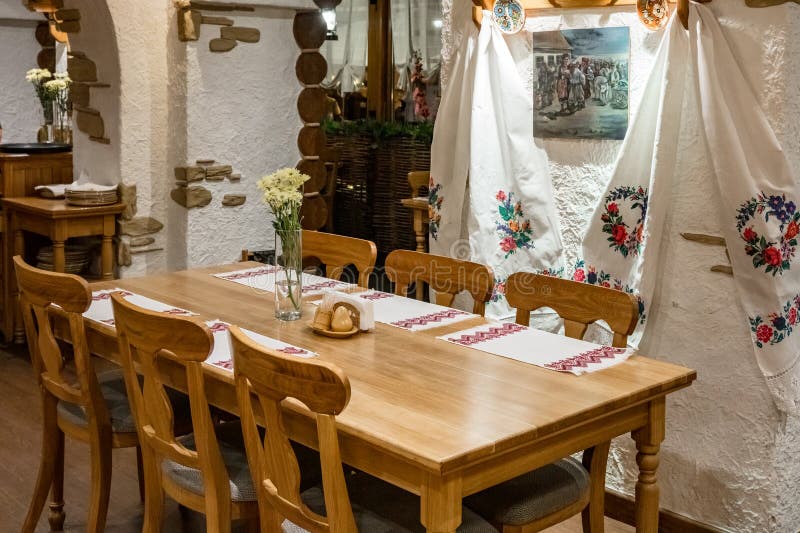 A Wooden Dining Table with a White Cloth Draped Over it Editorial Stock ...