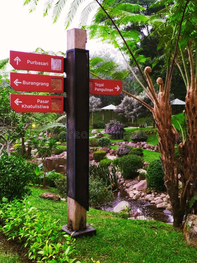 Wooden Direction Pole in Beautifull Garden Stock Image - Image of ...