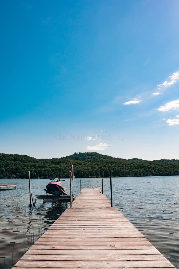 Wooden Dock and Motorboat on a Lake Stock Photo - Image of calm ...