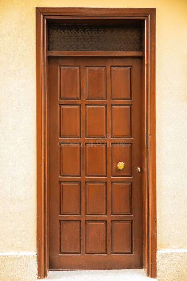 Wooden Door with Square Panels and Brass Handle in Brown Frame Stock ...