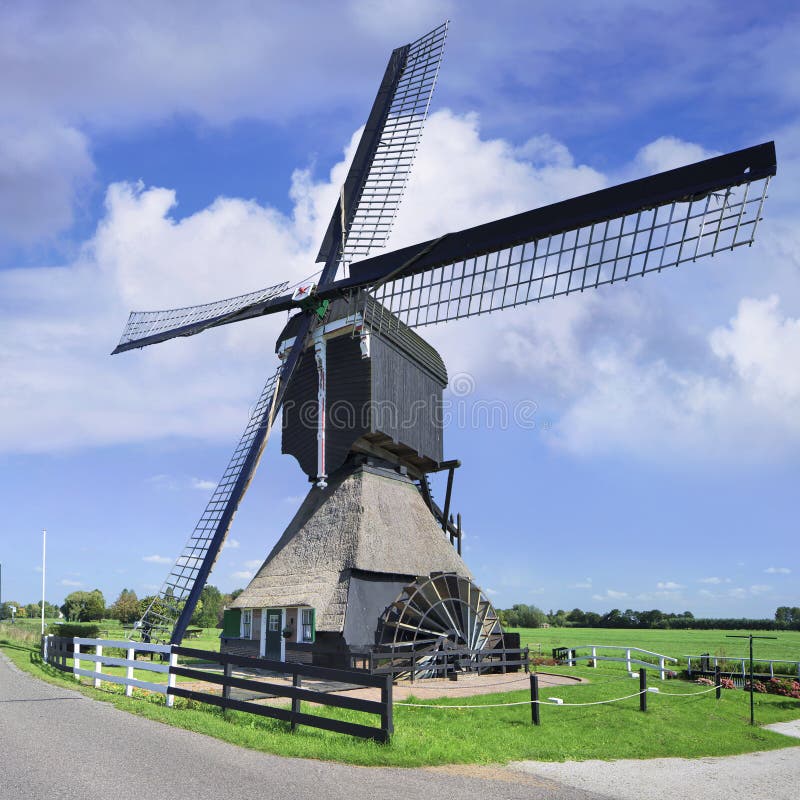 Wooden Drainage Windmill with a Water-wheel Against Blue Sky, the ...