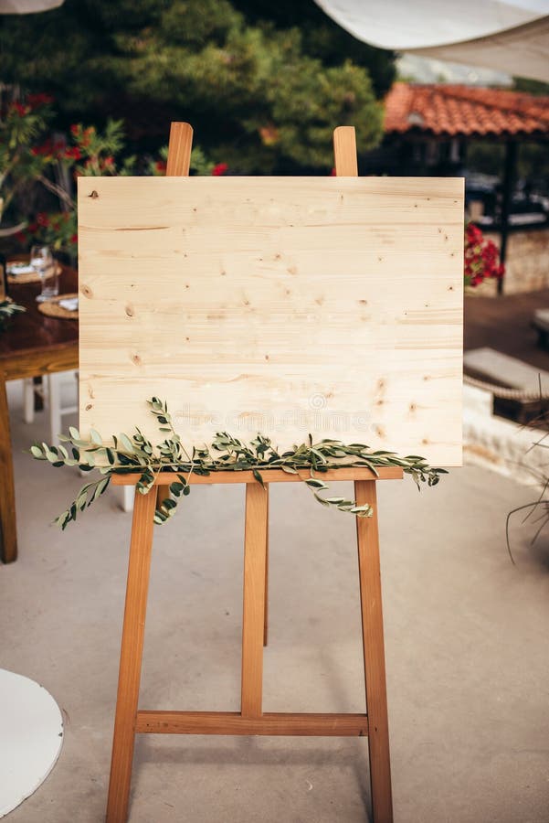 Wooden easel with a board stock image. Image of wedding - 286240133