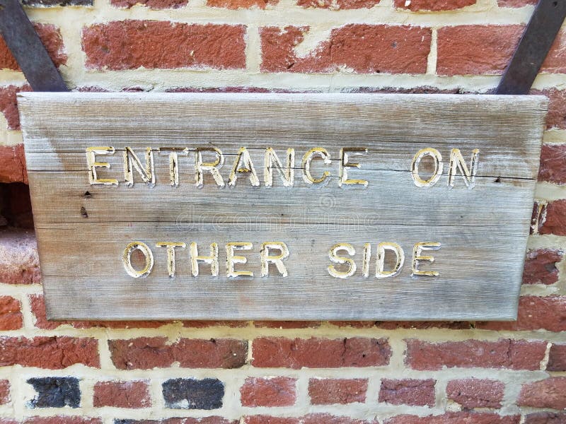 Wooden Entrance on Other Side Sign on Red Bricks Stock Photo - Image of ...