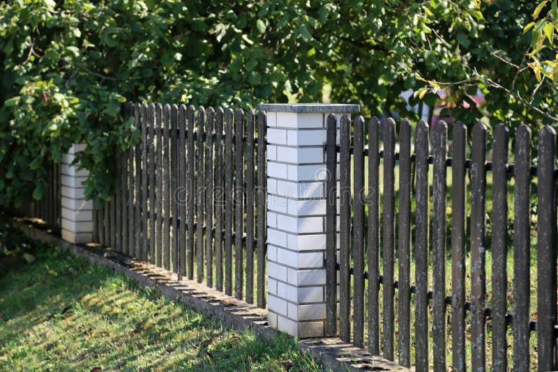 Wooden Fence with a Brick Pole in a Garden Stock Image - Image of wall ...