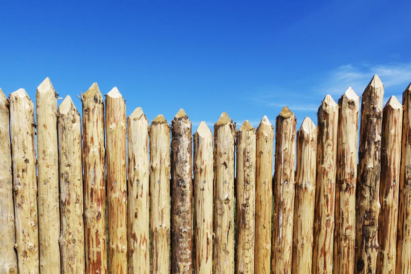 Wooden Fence Made of Sharpened Planed Logs. Stock Photo - Image of ...