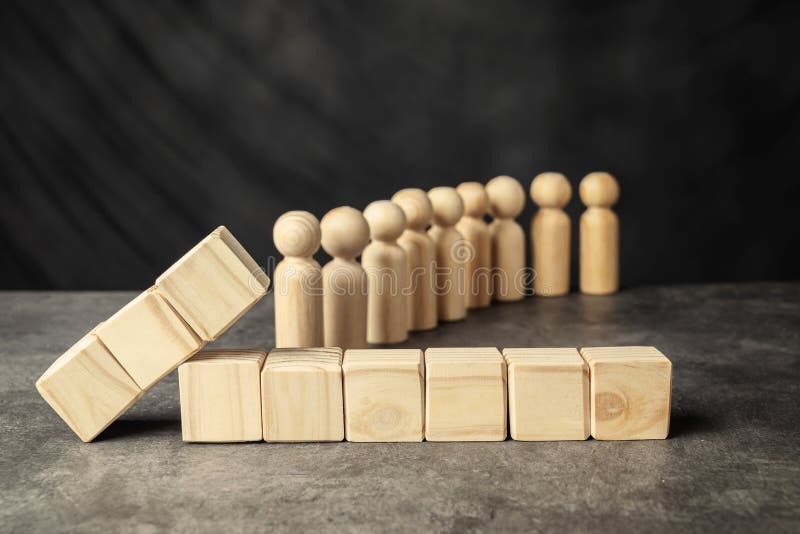 A Wooden Figure and a Row of Wooden Cubes Stock Photo - Image of ...