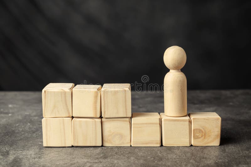 A Wooden Figure and a Stack of Wooden Cubes Stock Image - Image of ...