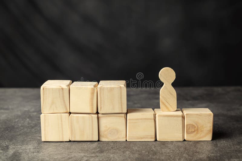A Wooden Figure and a Stack of Wooden Cubes Stock Photo - Image of ...