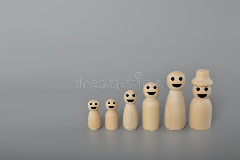 Wooden Figures of the Family Standing on the Grey Background Stock ...