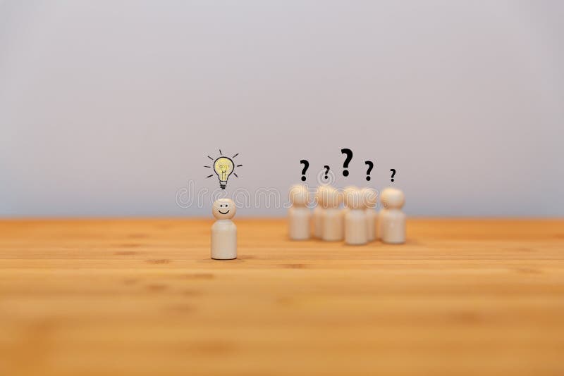 Wooden Figures of People Confused with Question Marks and an Idea Bulb ...