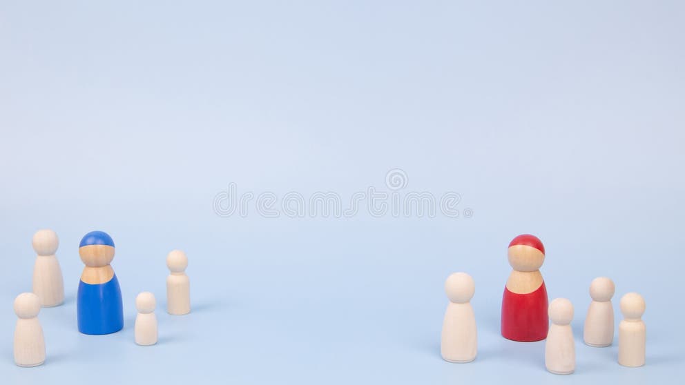 Wooden Figures in Two Separate Groups on Blue Background Stock Photo ...