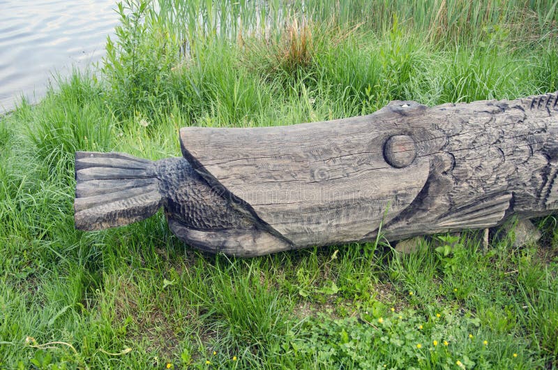Wooden Fish Sculpture in Park Stock Image - Image of water, concept ...