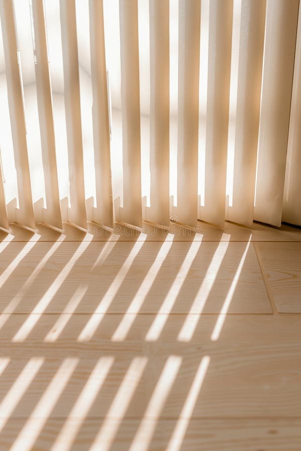 A Wooden Floor with a Light Shining through the Blinds Stock Photo ...