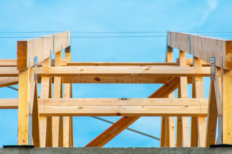 Wooden Framework Construction Under a Bright Blue Sky - Architectural ...