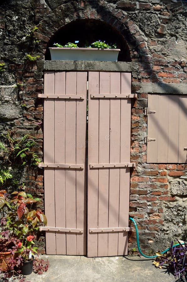 Wooden gate on brick wall stock image. Image of outdoors - 55647211