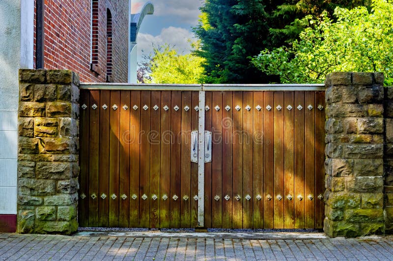 Wooden Gate with Brick Wall and Tree in the Back Ground in Germany ...