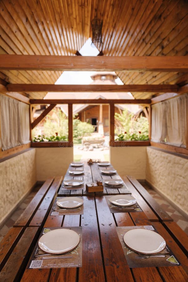 Wooden Gazebo with Table Setting Inside. Rustic Restaurant in Village ...