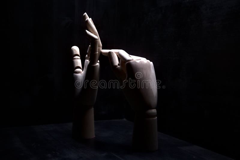A Wooden Hand that is Pointing while Another One Dodges the Forefinger ...