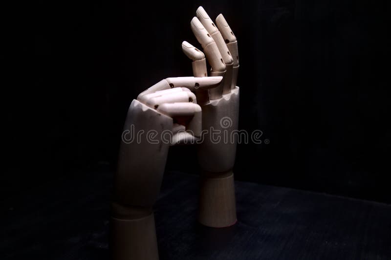 A Wooden Hand that is Pointing while Another One Dodges the Forefinger ...