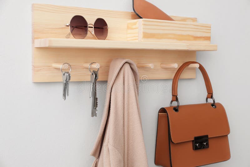 Wooden Hanger for Keys with Different Stuff on Light Grey Wall Stock ...